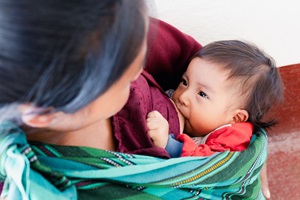 Sara breastfeeds her six month old son
